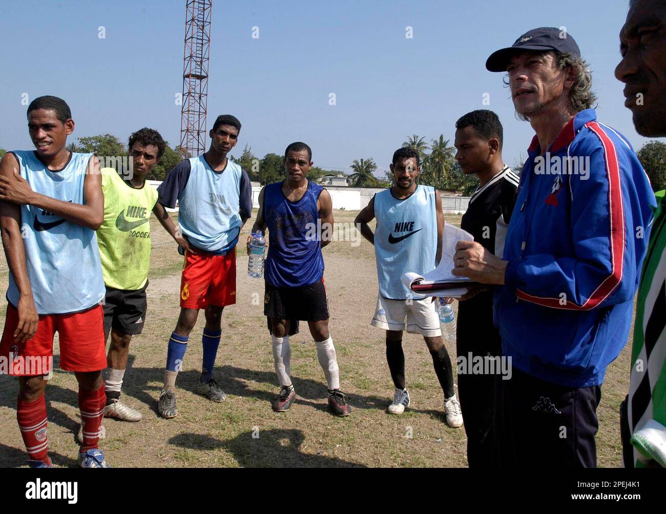 East Timor's football coach Jose Luis, right, of Portugal, talks to ...