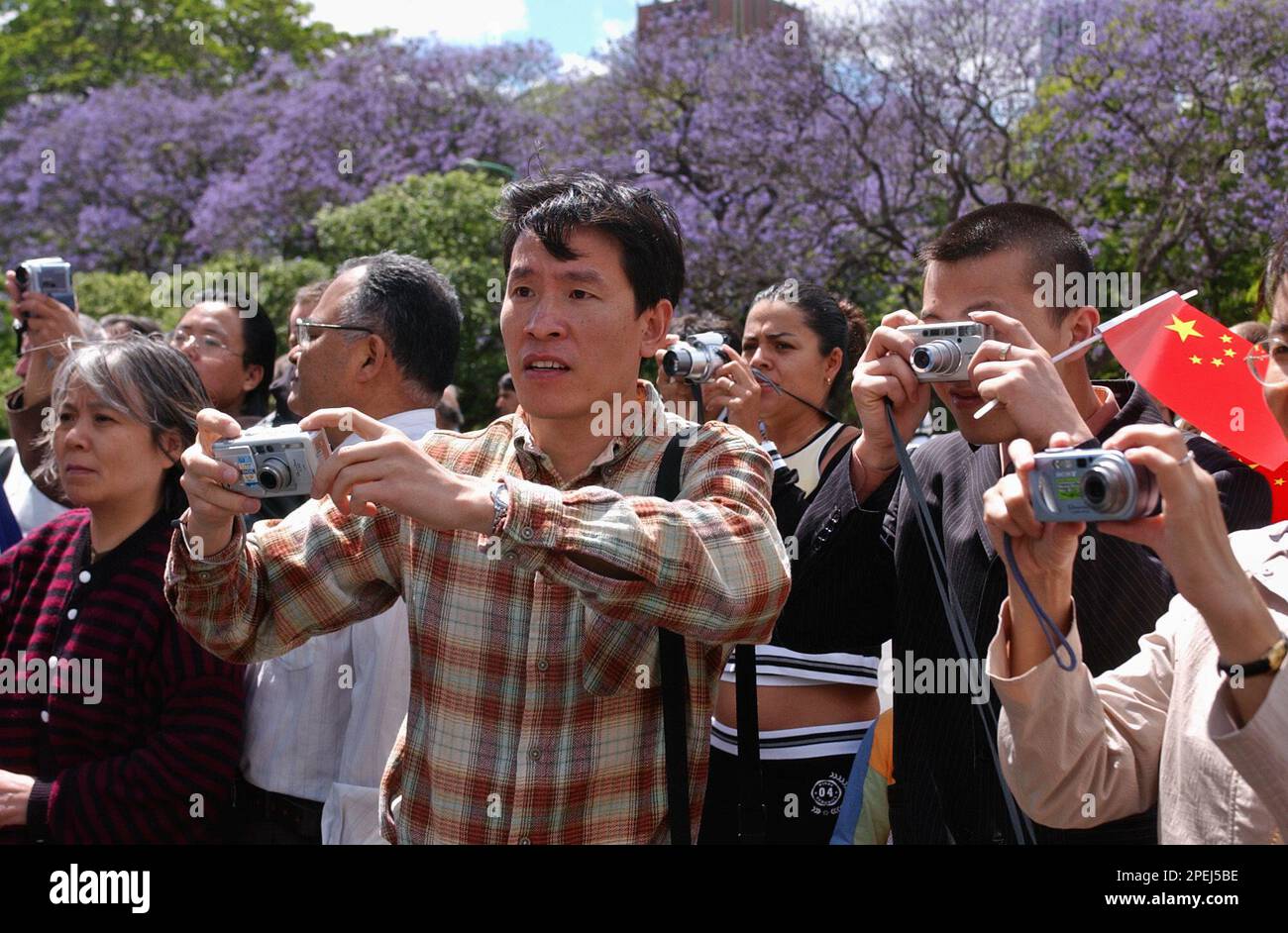 People take pictures of Chinese President Hu Jintao, as he leaves Plaza ...