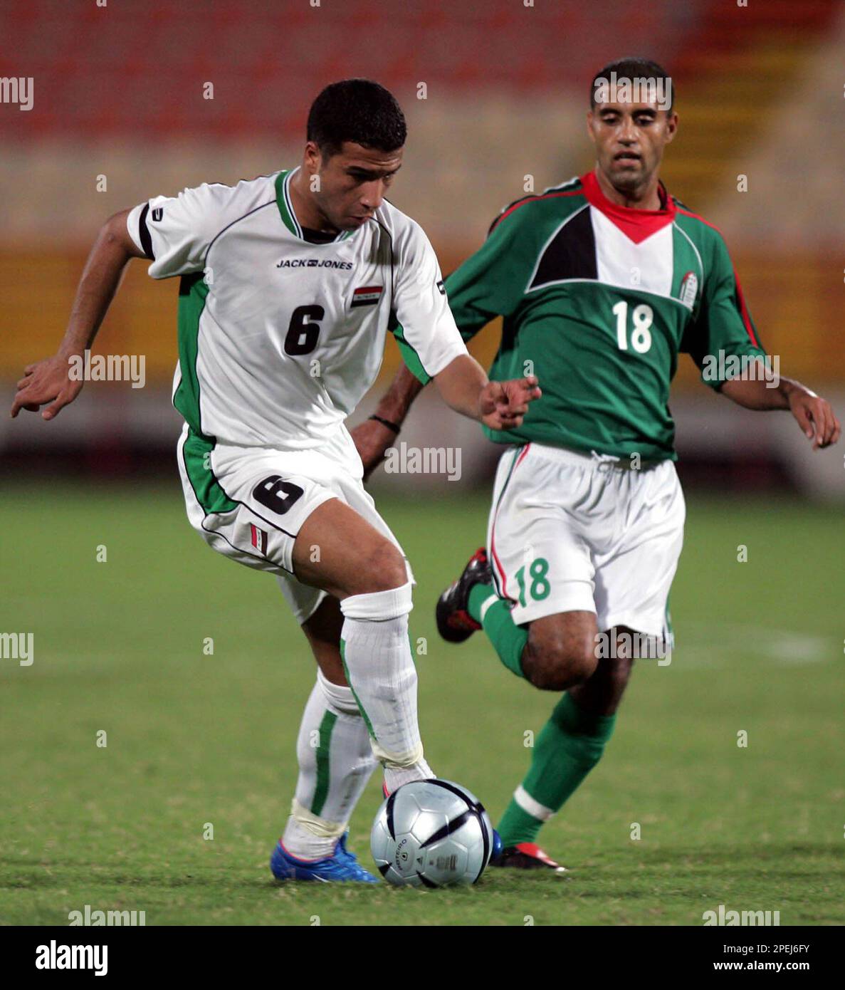Iraqi national soccer player Saleh Sadir, left, steers the ball away ...