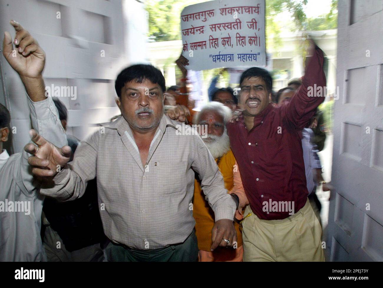 Hindu nationalists shout slogans as they enter a police station during ...