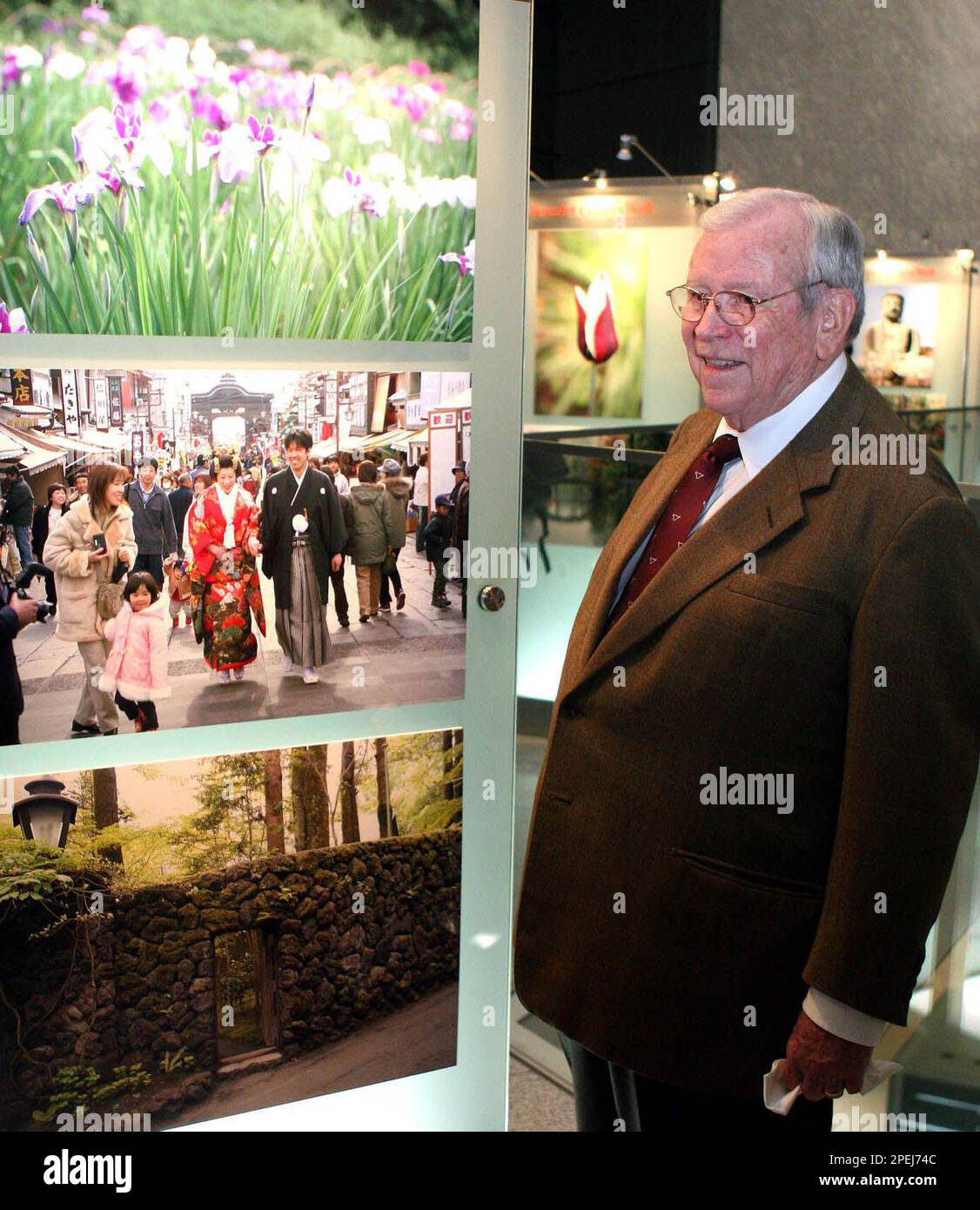 U.S. Ambassador to Japan Howard Baker poses in front of his photographs ...