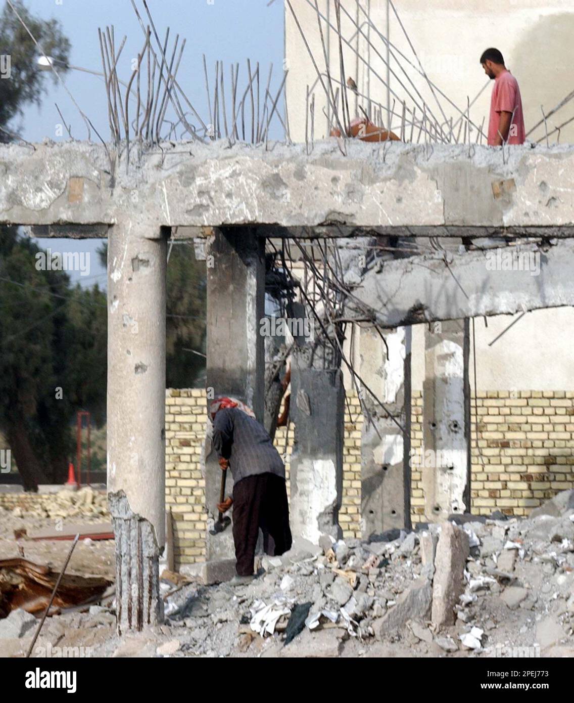 Iraqi workers dismantle the remains of the former MSU Italian ...