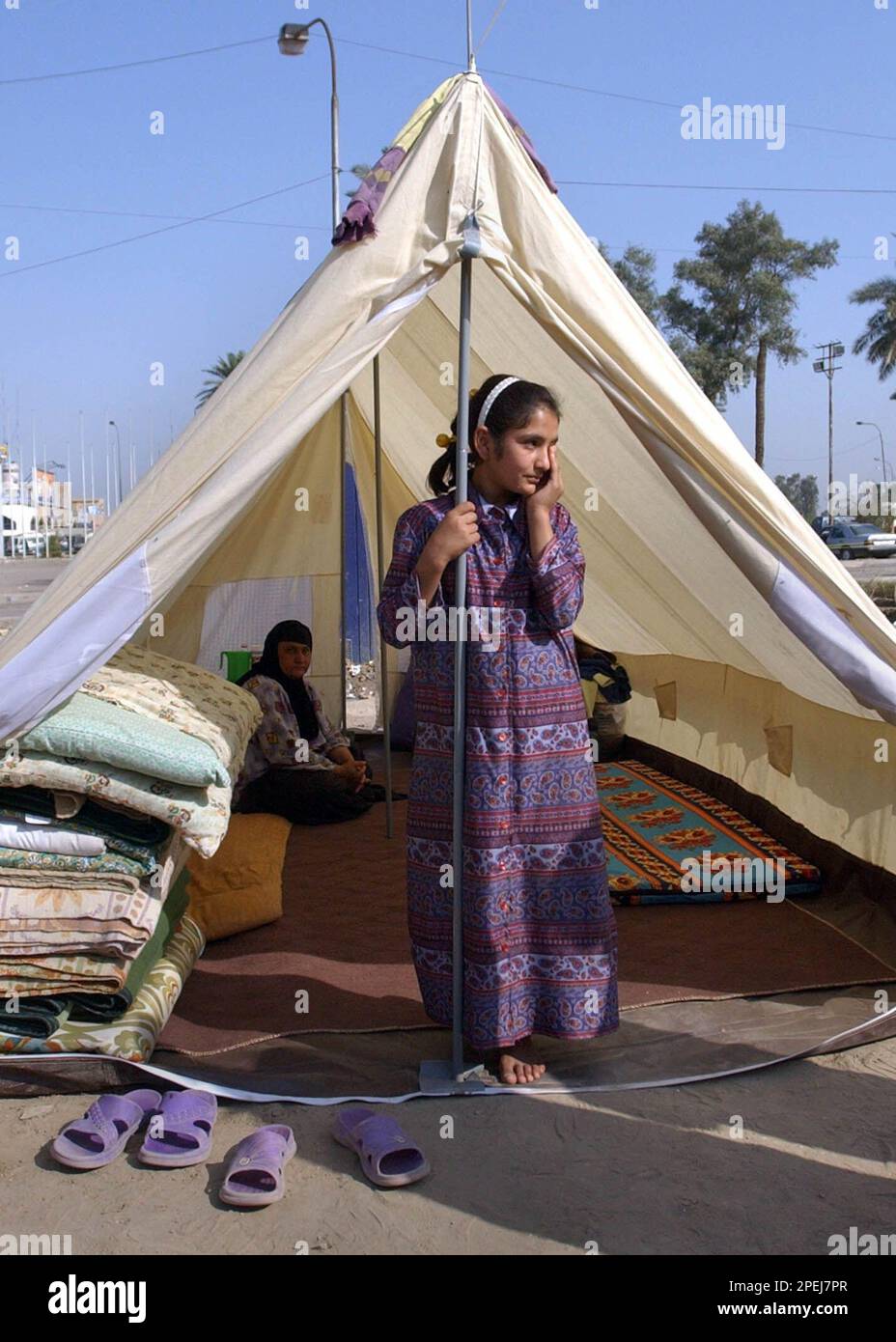 Sarah Natik, 14, stands at the edge of her tent at a Red Crescent ...
