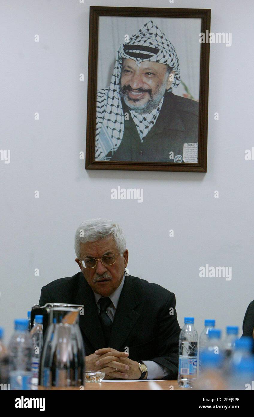 Palestinian Authority Chairman Mahmud Abbas sits under a portrait of ...