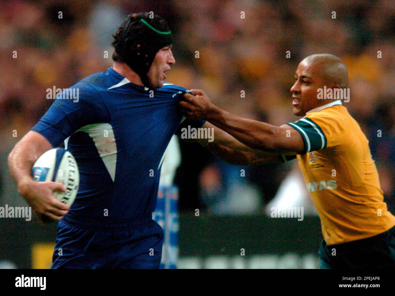 Austalian's Georges Gregan, right, grabs French's Olivier Magne during ...