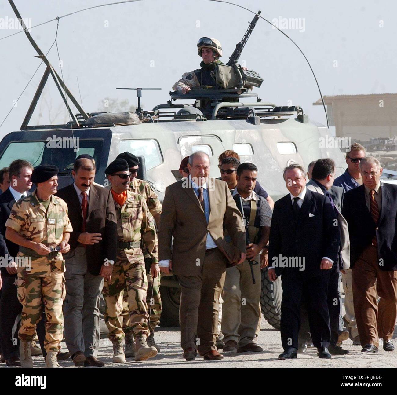 Iraqi interim Prime Minister Ayad Allawi, center in brown suit, is ...