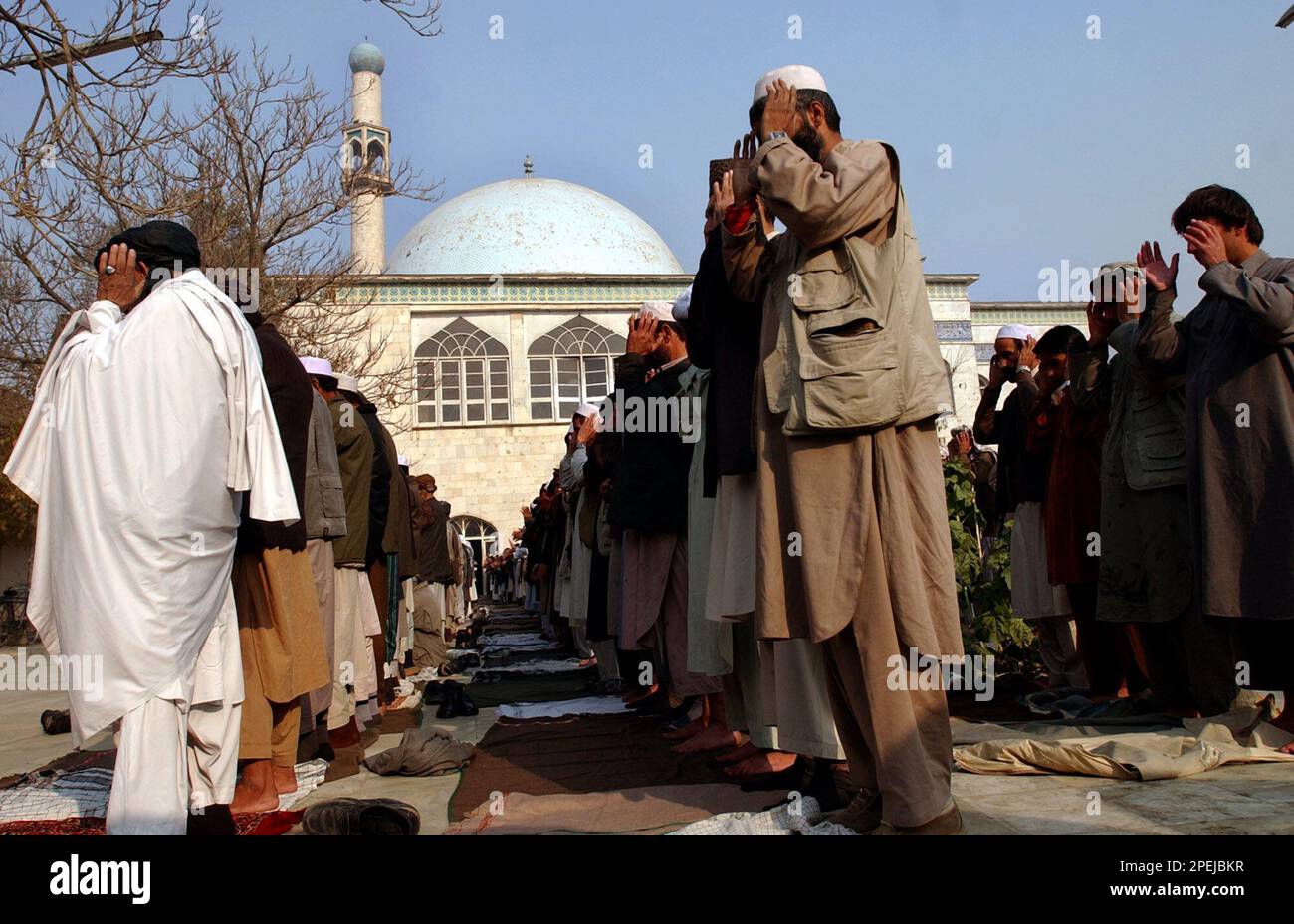 Afghan men pray during the first day of Eid al-Fitr in Kabul ...