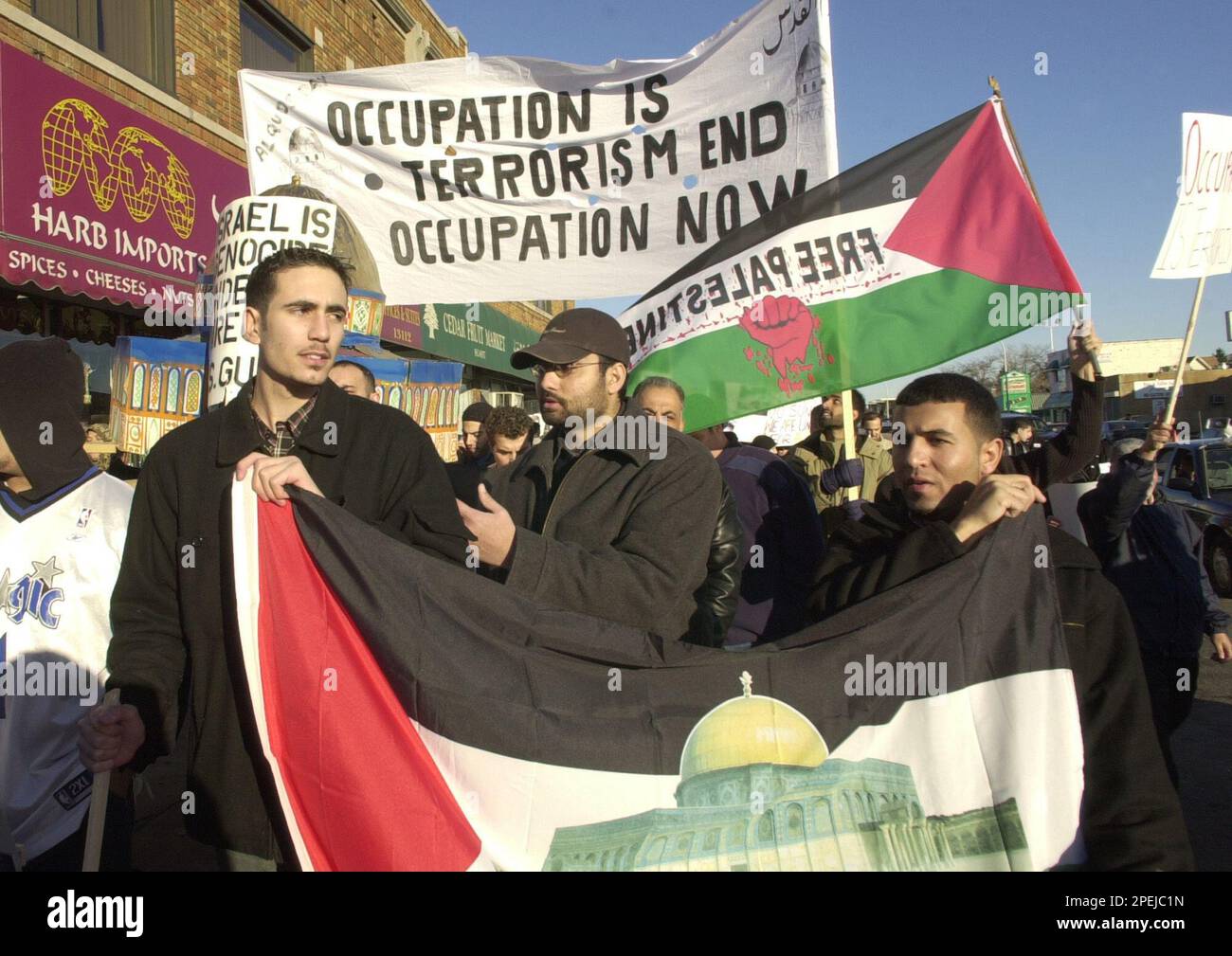 Dozens of people march Friday, Nov. 12, 2004, in Dearborn, Mich., to ...