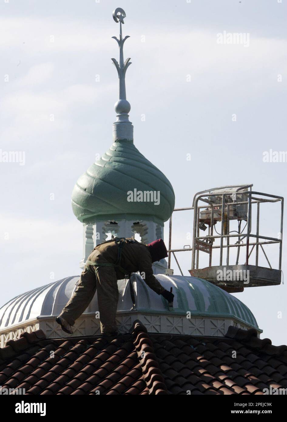 Jessie Booth, of EB Miller Co., paints the pinnacle of a gazebo in Eden ...