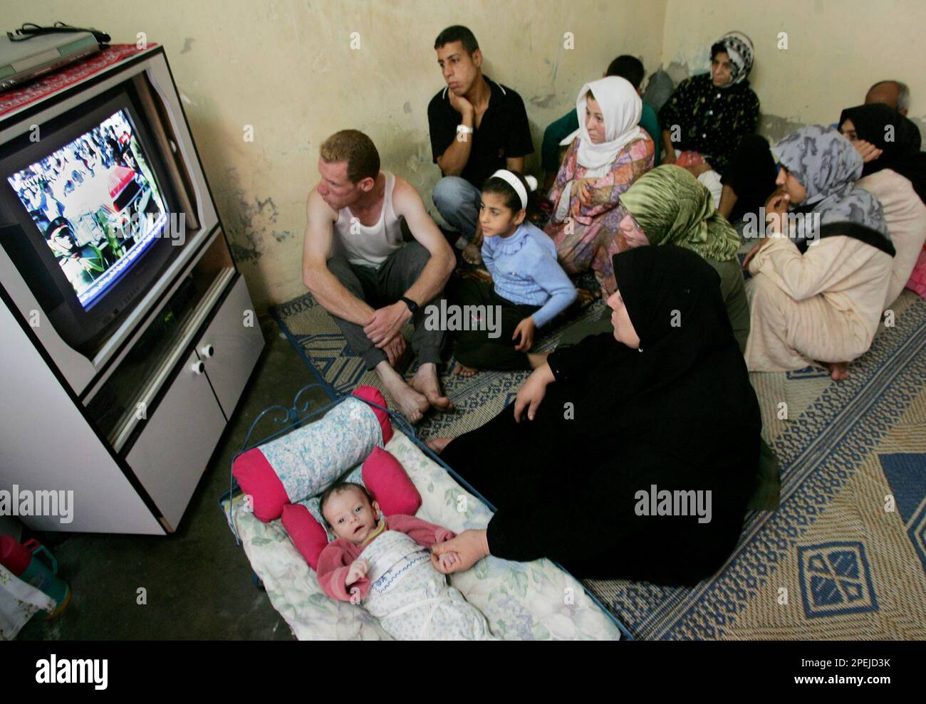 The Jaballah family watches the Cairo, Egypt, funeral for Yasser Arafat ...