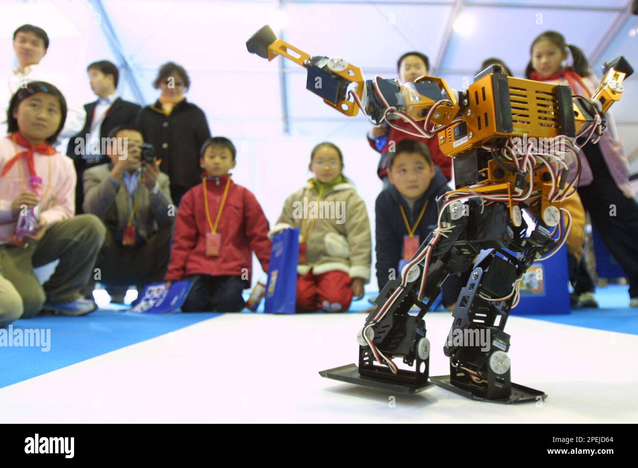Visitors look at a remote controlled robot made by Japanese company BL Autotec at an ...