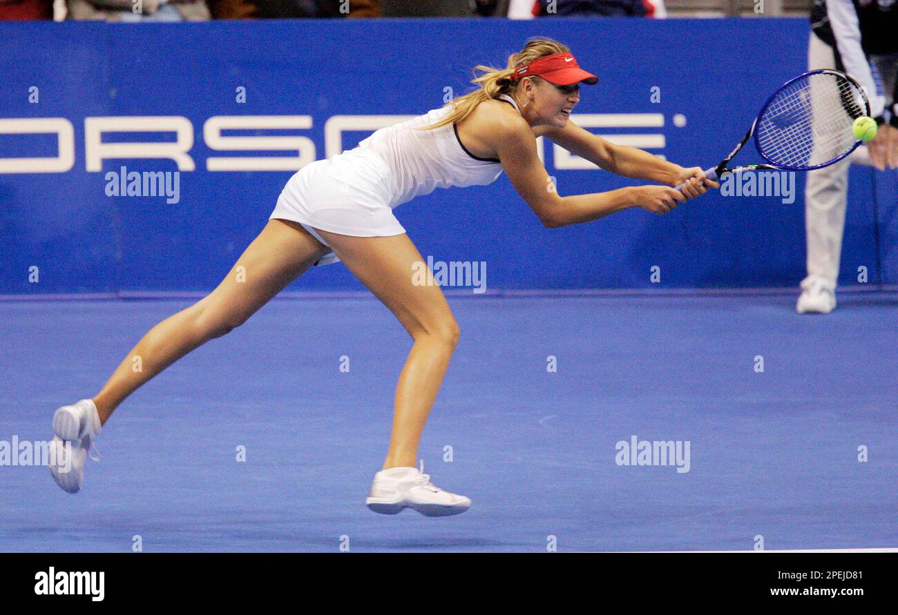 Maria Sharapova of Russia returns a shot to Svetlana Kuznetsova of ...