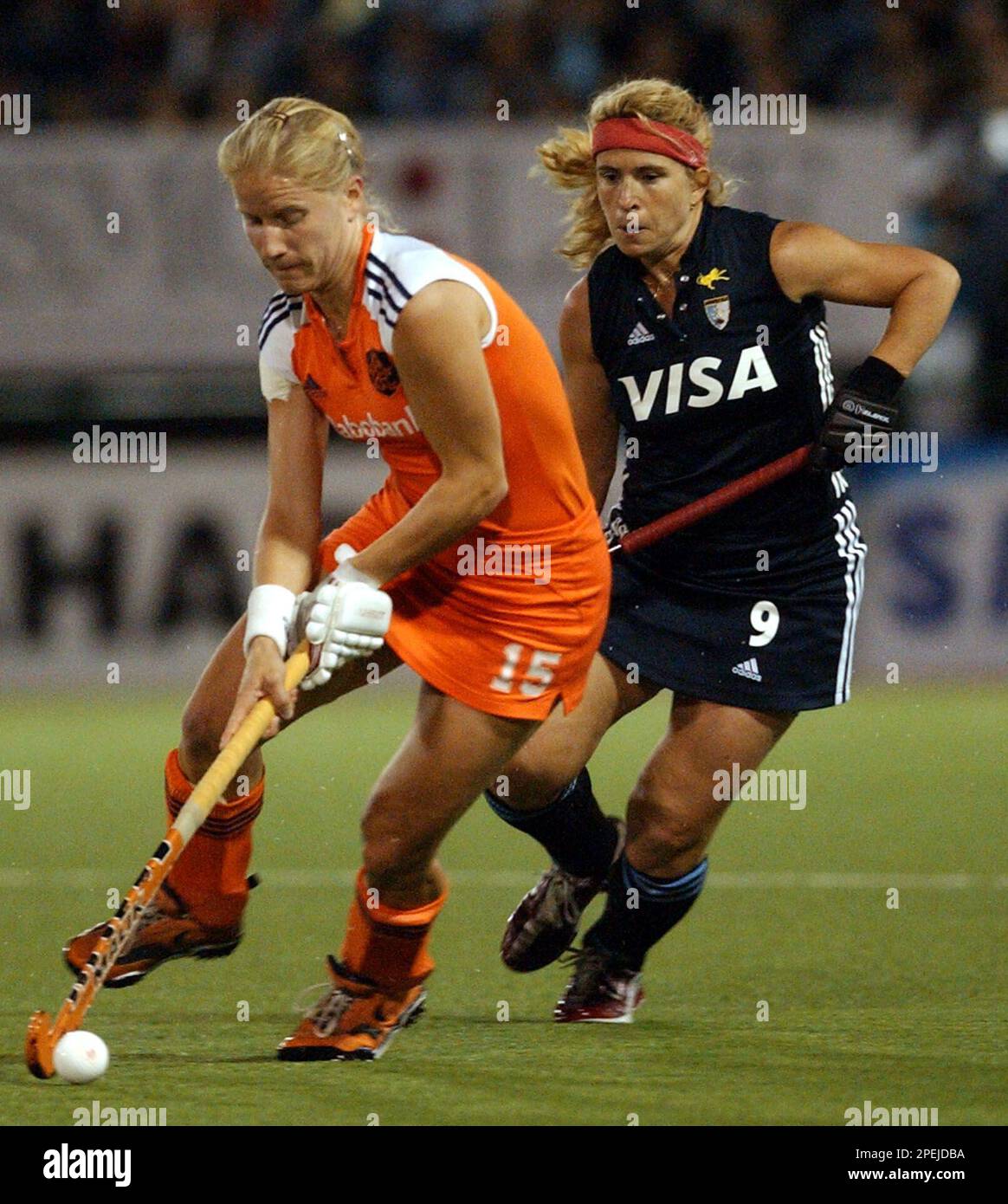 Janneke Schopman , left, of Netherlands hits the ball as Vanina Oneto ...