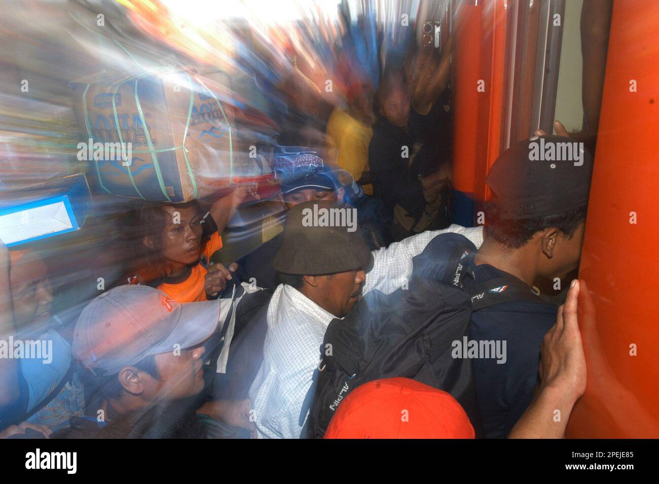 Indonesians crowd to board a train at Senen train station in Jakarta ...