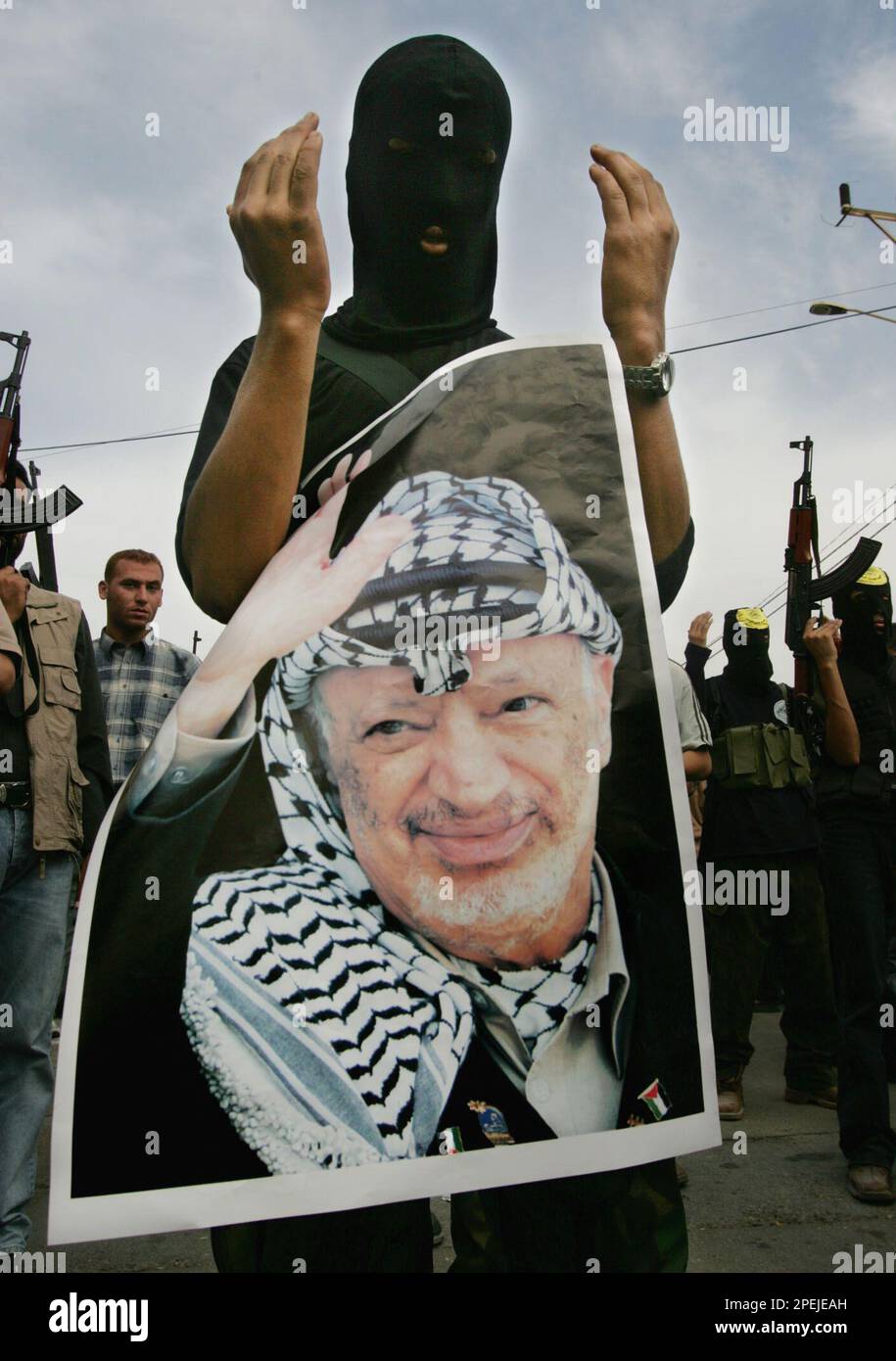 A Palestinian masked militant from the Al Aqsa MArtyrs Brigades prays ...