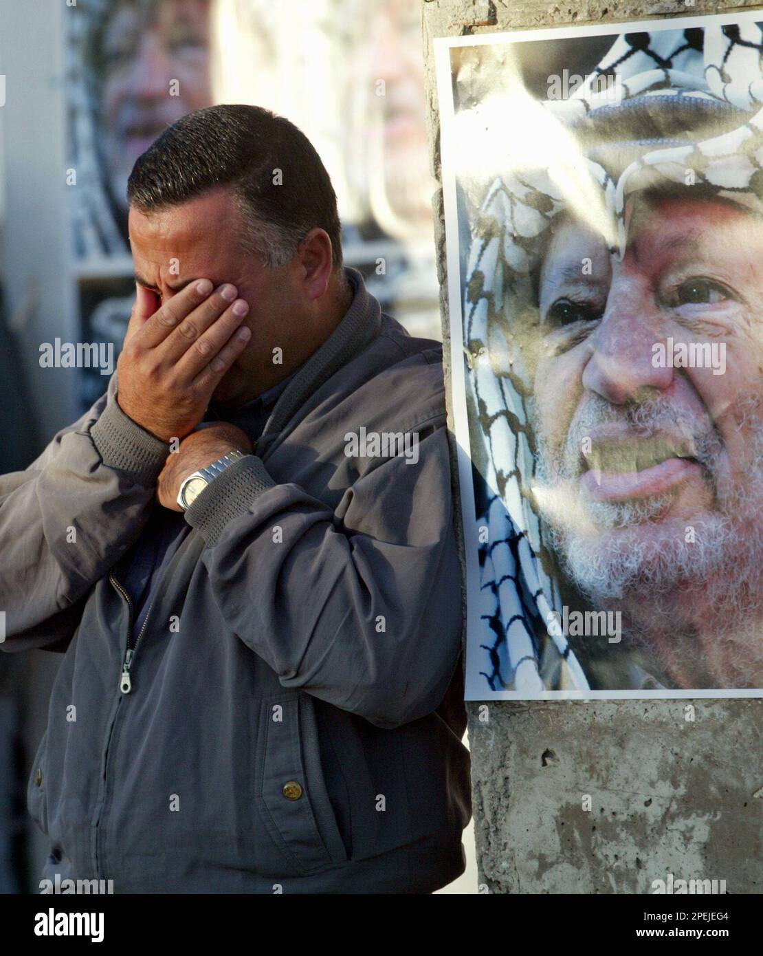 A Palestinian man reacts after Palestinian leader Yasser Arafat's death ...