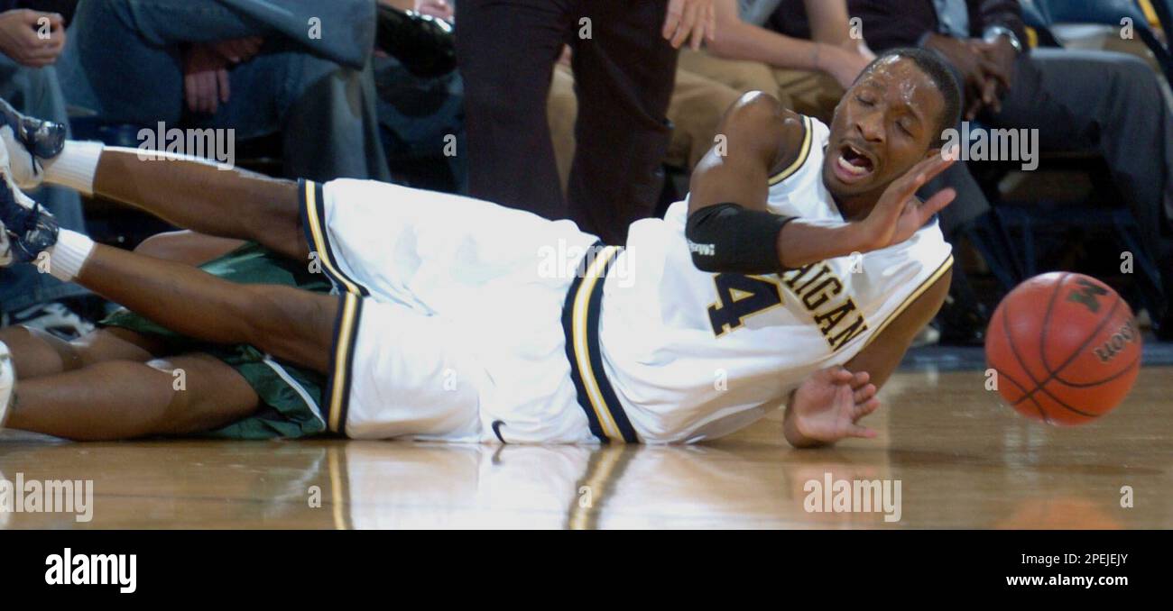 Michigan's Daniel Horton hits the deck after falling over Wayne State's ...