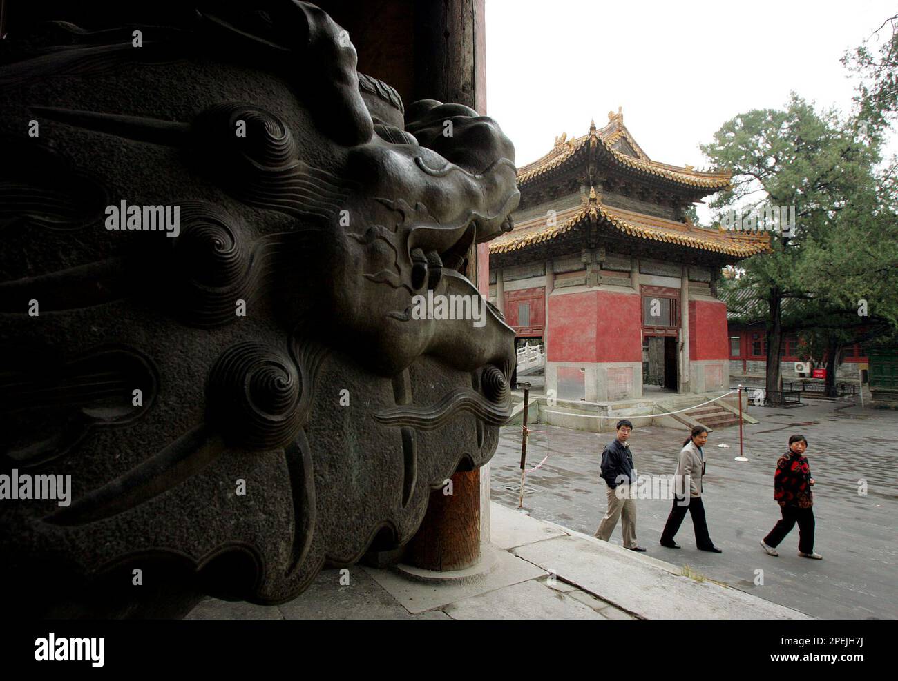 Visitors walk past a decorative dragon head at the Confucian Temple in ...