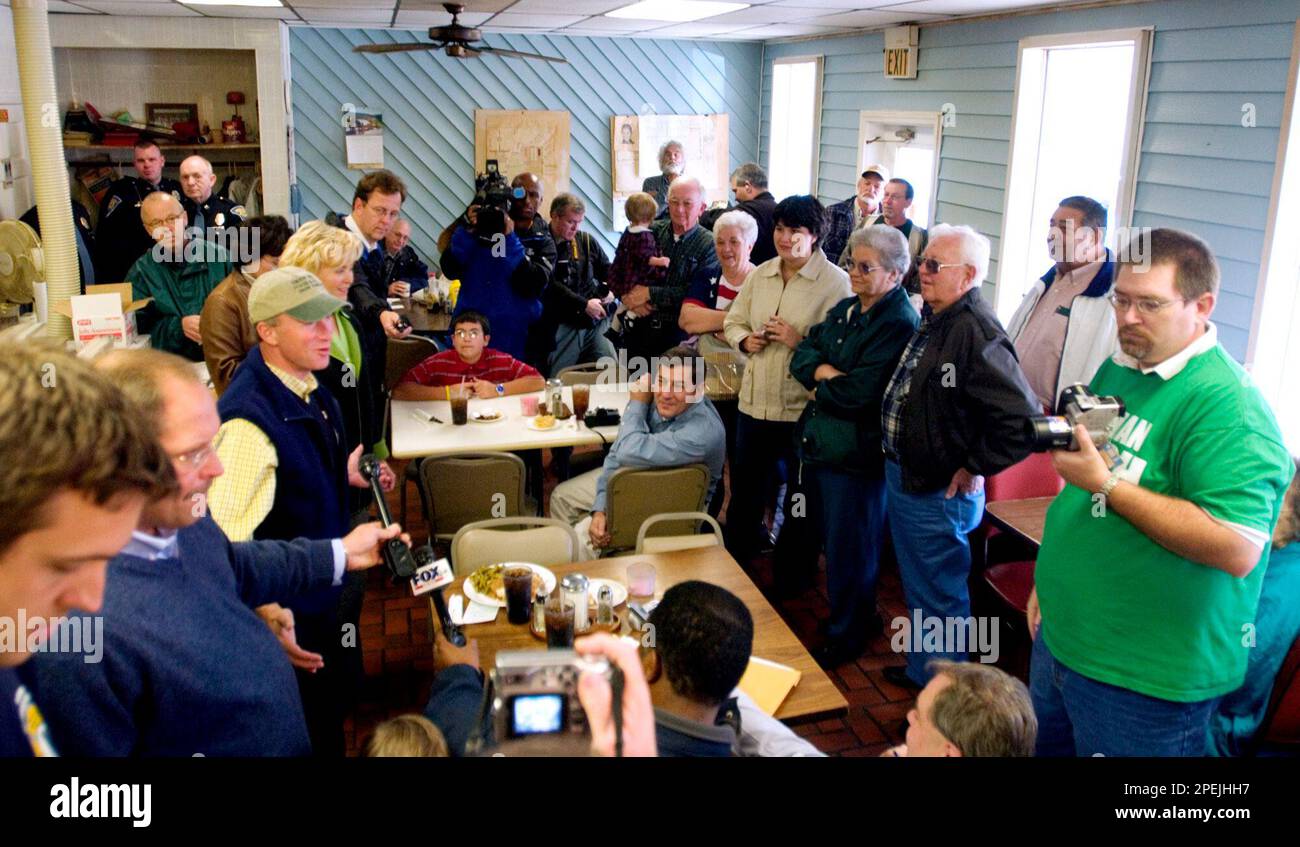 Indiana Governor-elect Mitch Daniels, left wearing cap, and running ...