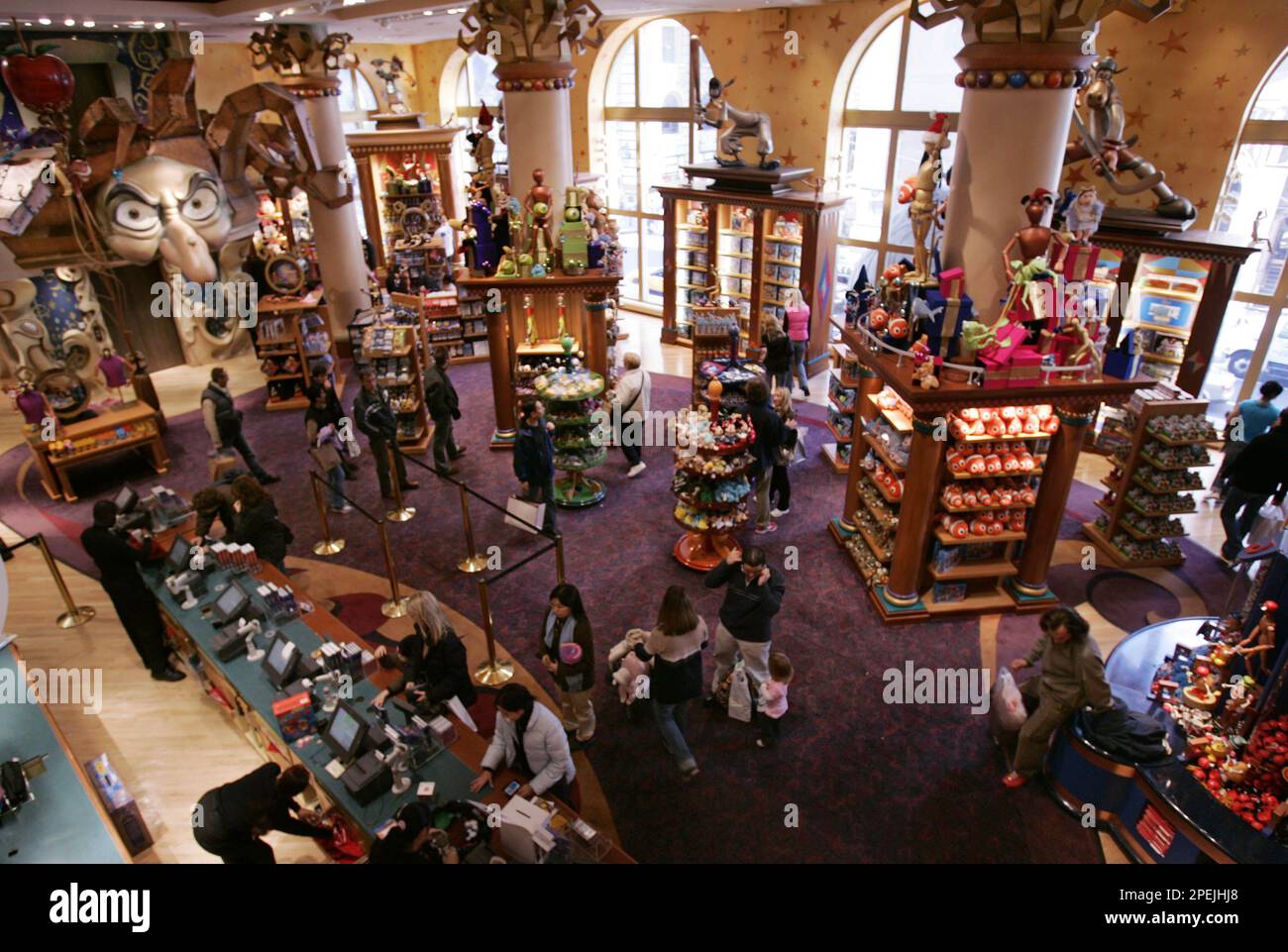 People shop at the World Of Disney store on New York's Fifth Avenue ...
