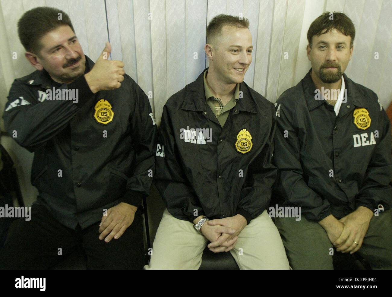 U.S. Drug Enforcement Agency agents, Robert Deak,right, Kyle Kent ...