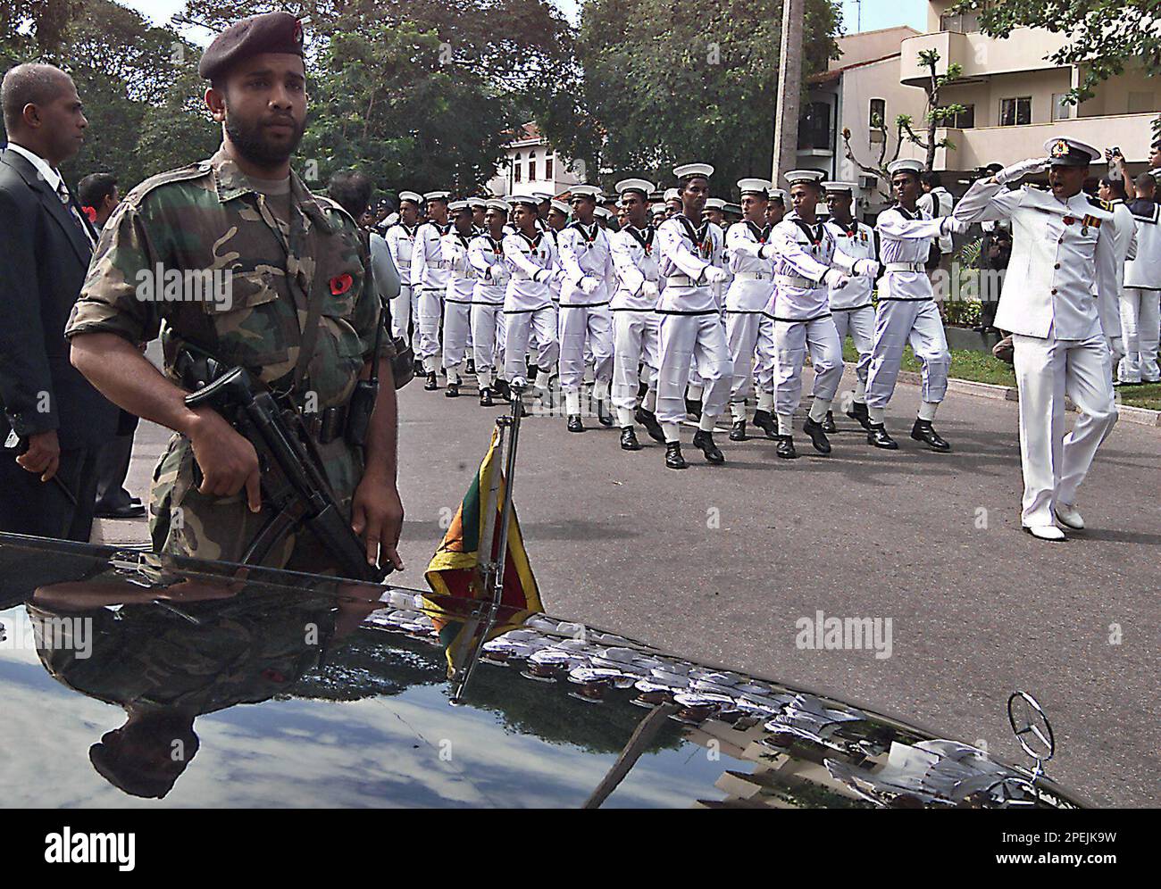A Sri Lankan soldier stands guard as soldiers march during a ceremony held to commemorate war ...