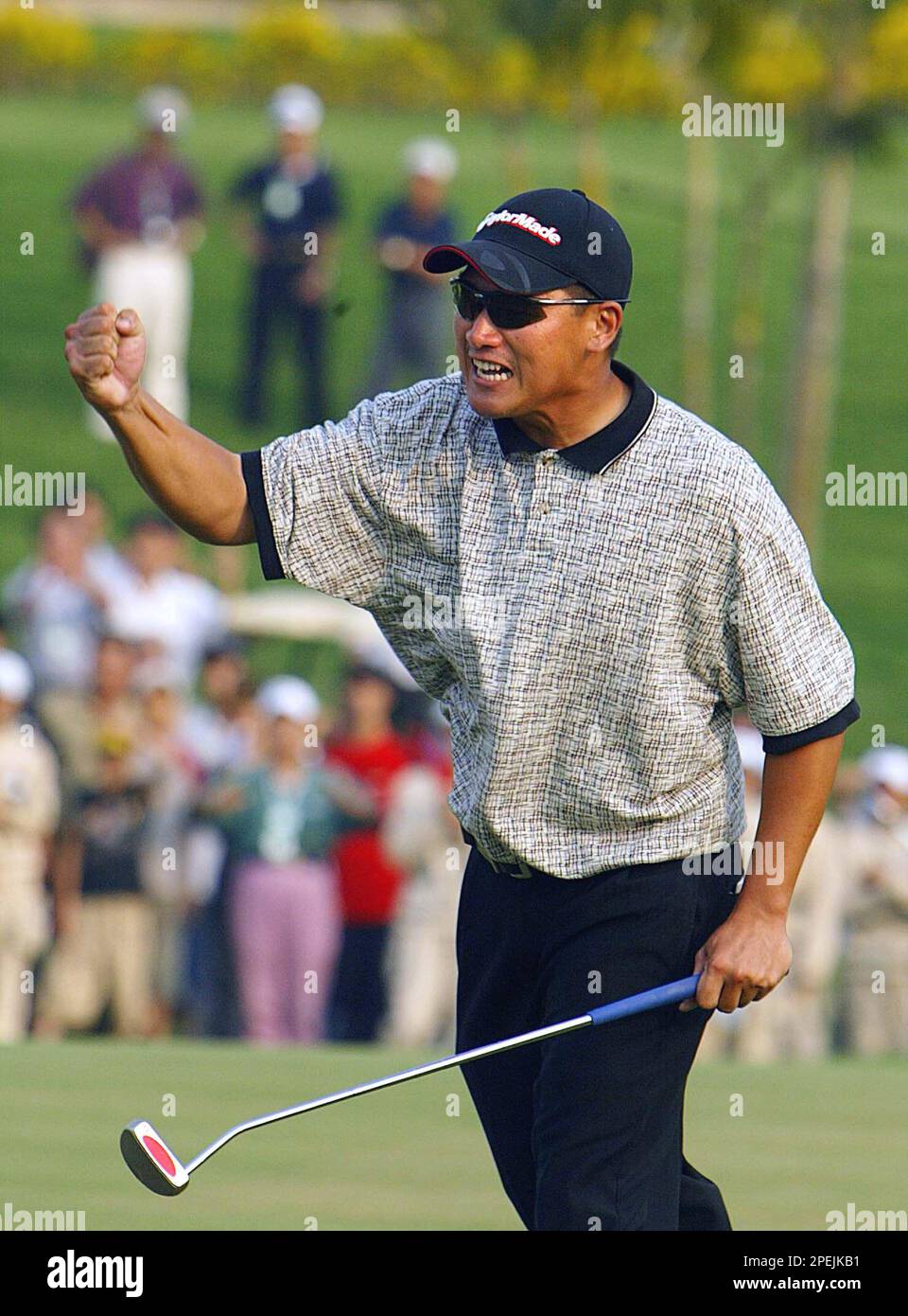 Angelo Que from the Philippines reacts after sinking the winning putt ...