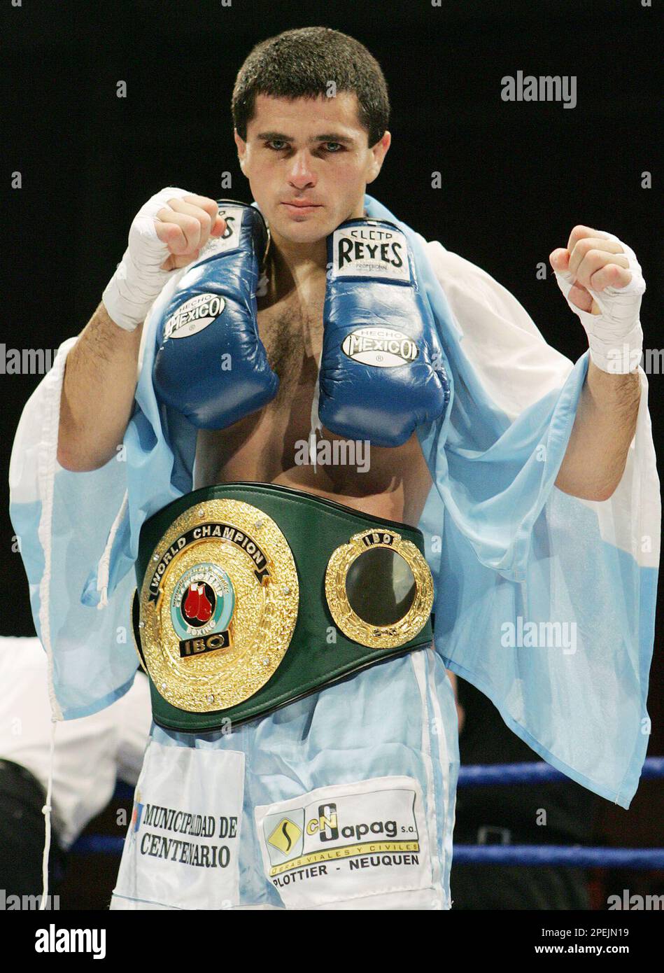 Argentina's Aldo Rios poses in his countries National Flag, with the IBO Lightweight belt after ...