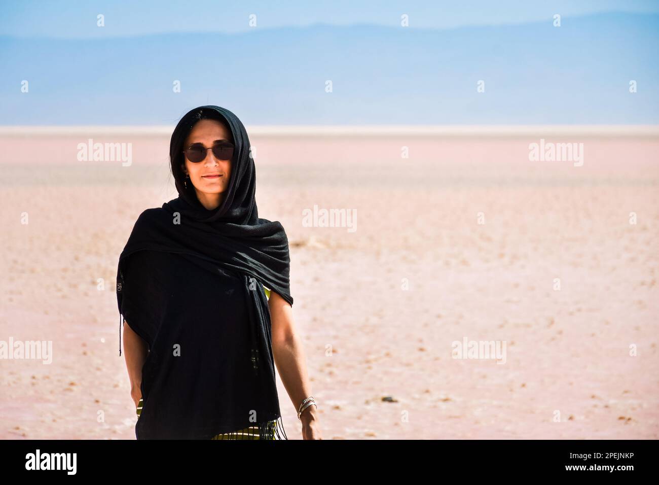 Caucasian woman tourist stand on Maharlu pink salt lake shore. Travel ...