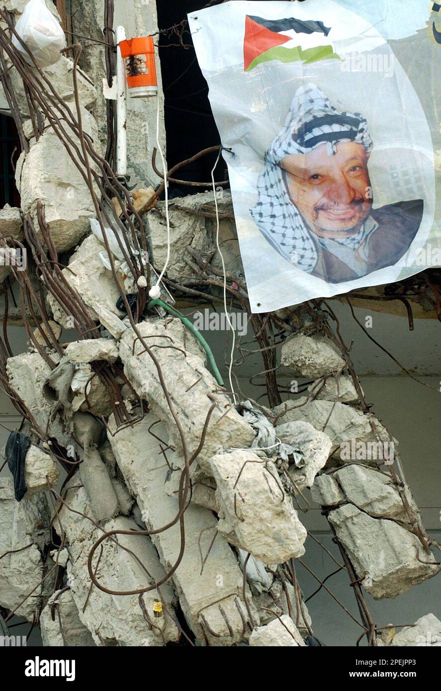 A poster of Palestinian Leader Yasser Arafat is seen at his battered ...