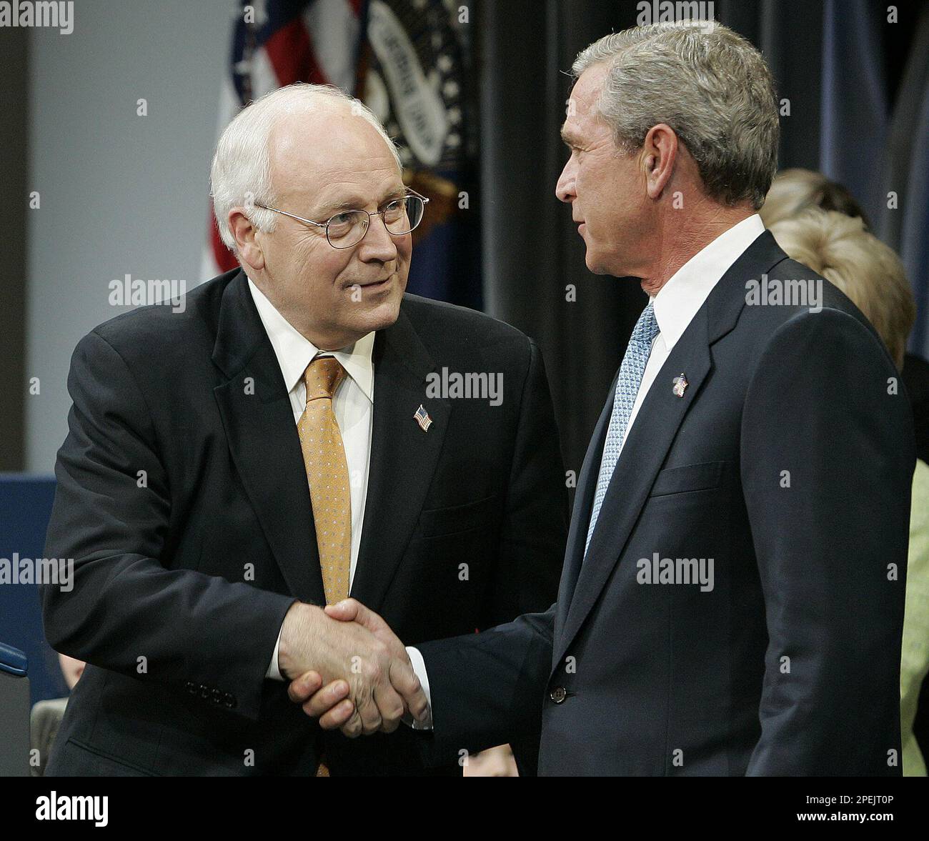 Vice President Dick Cheney shakes hands with President Bush at a ...