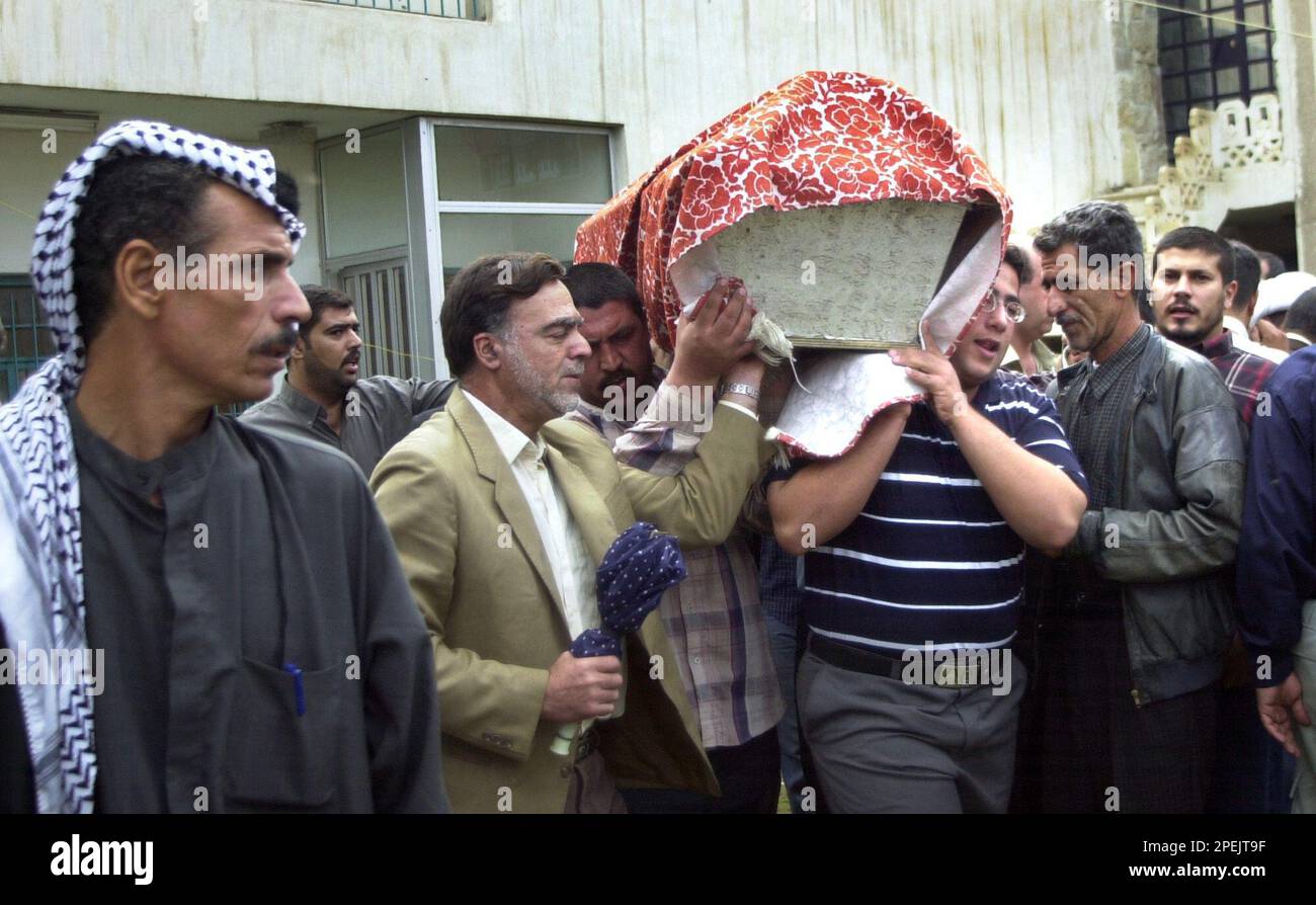 Family members carry the coffin of Hussein Mohammed Ali, a senior ...