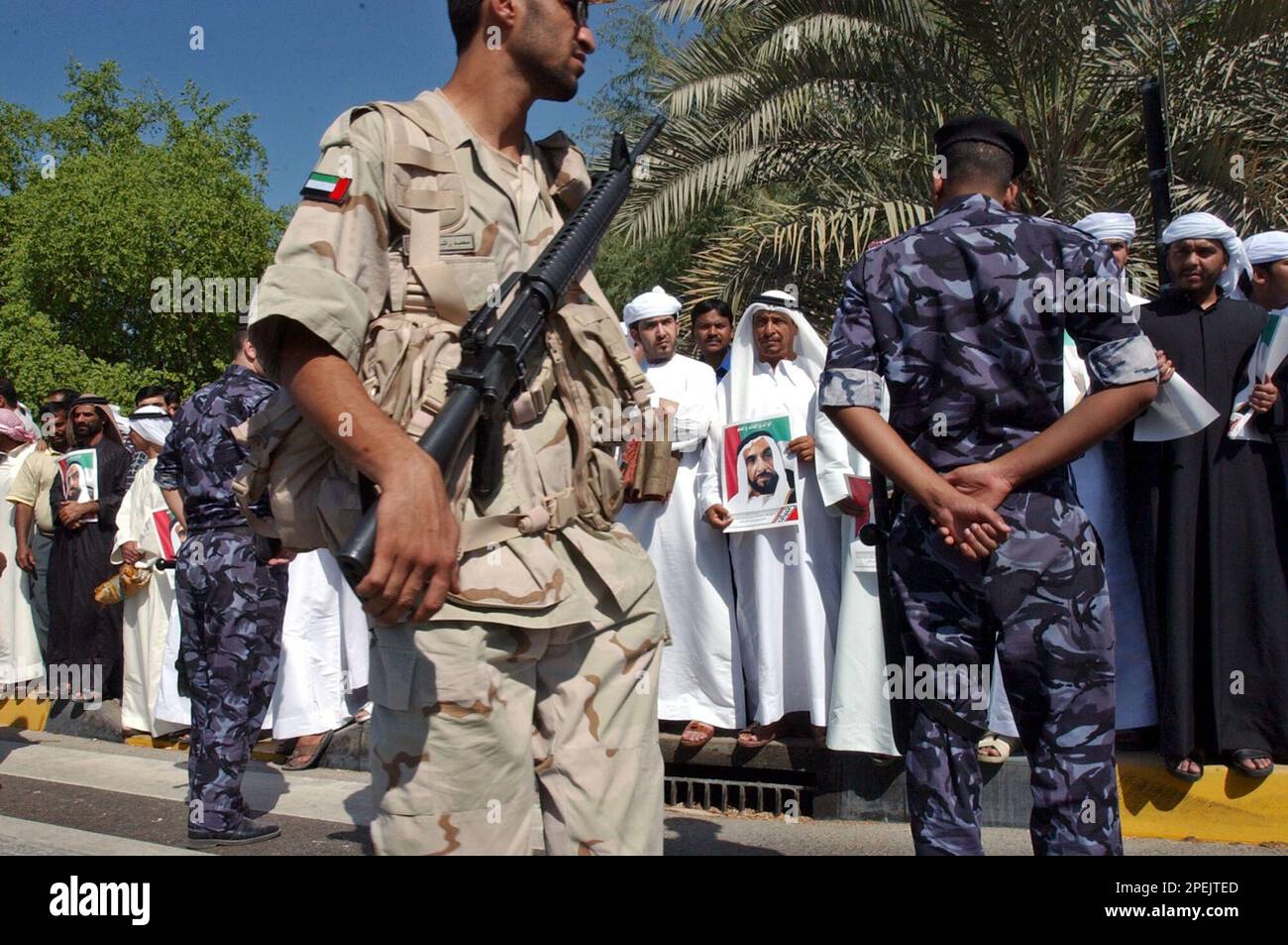 An Emirates soldier passes mourners waiting for the begining of funeral ...