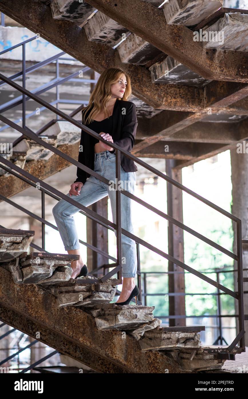 Beautiful woman walking up the stairs looking over shoulder Stock Photo ...