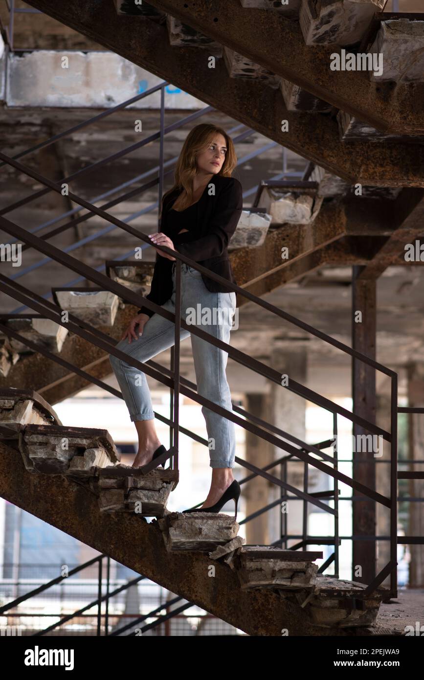 Beautiful woman walking up the stairs looking over shoulder Stock Photo ...