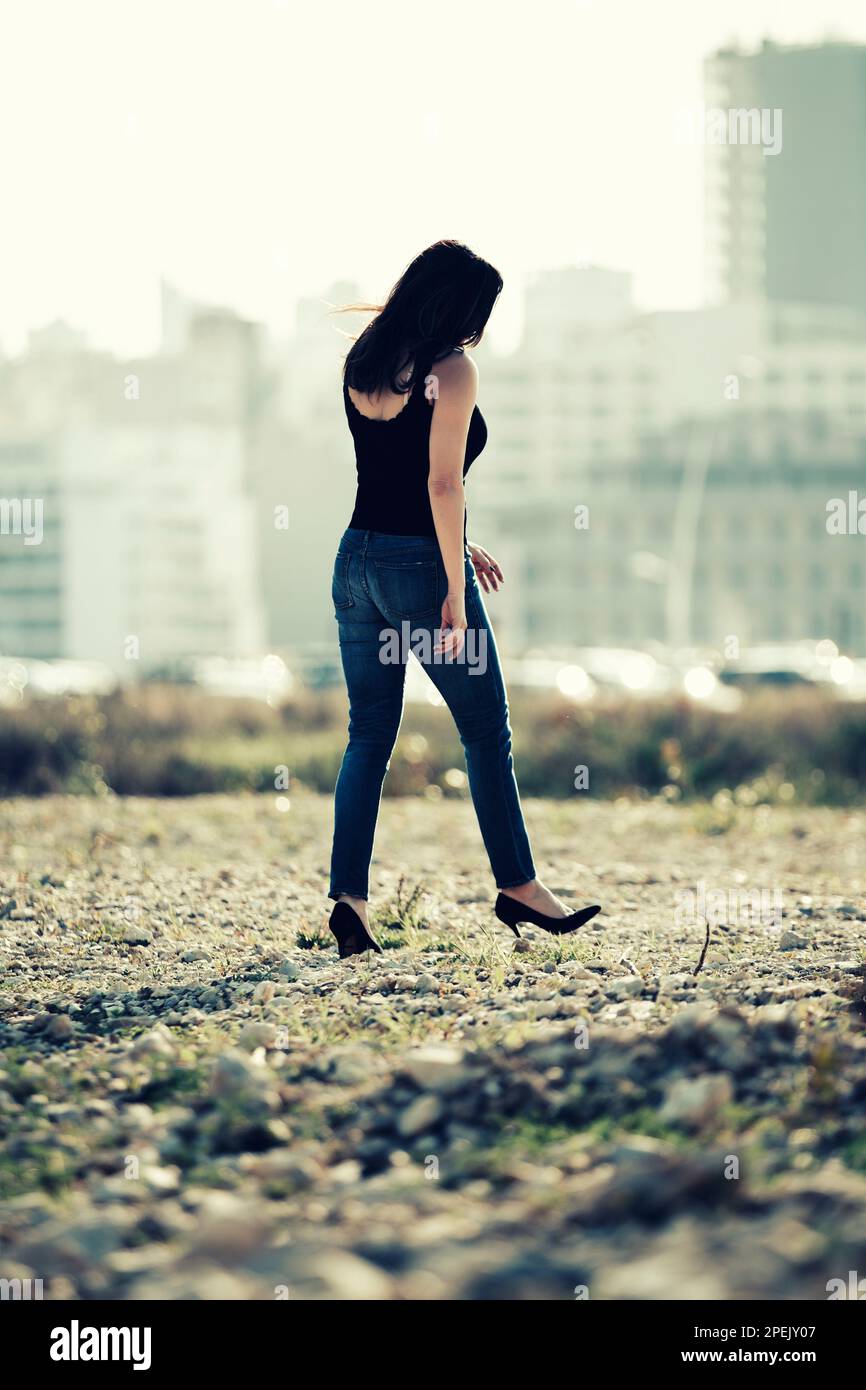Rear view of woman walking away Stock Photo - Alamy