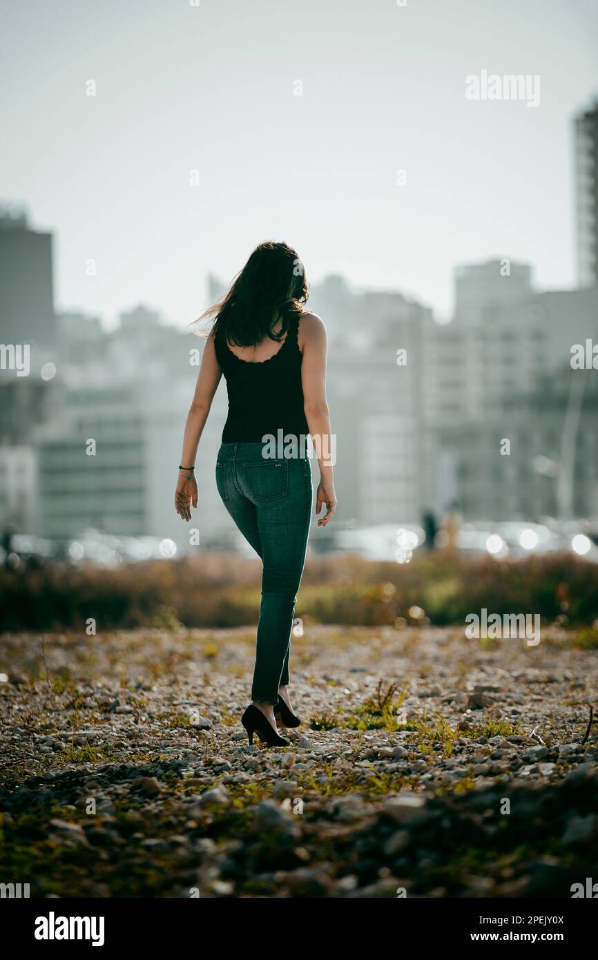 Rear view of woman walking away Stock Photo - Alamy