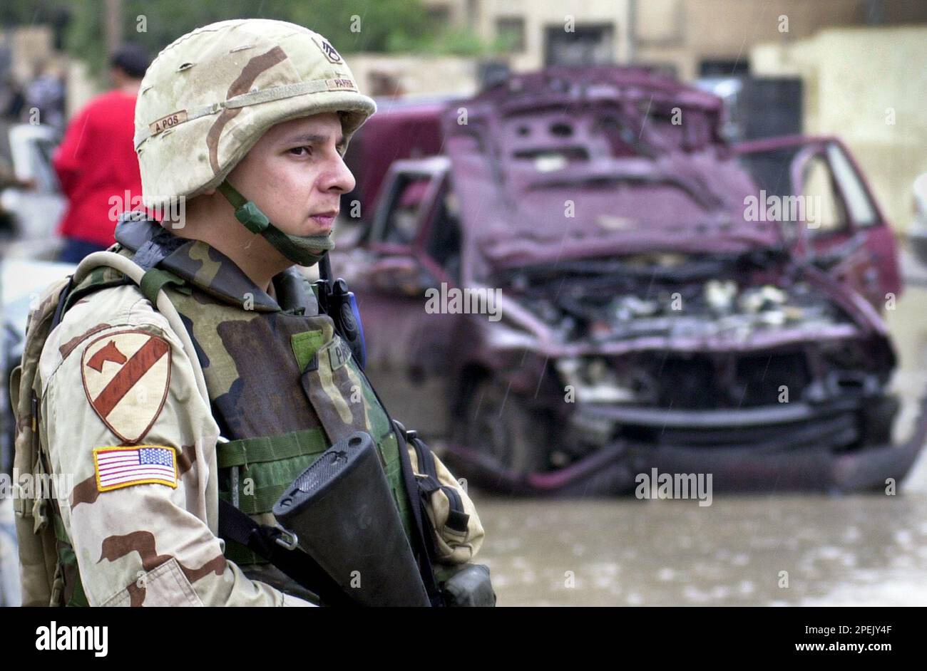 A U.S. Army soldier guards the site of a car bomb explosion near an ...