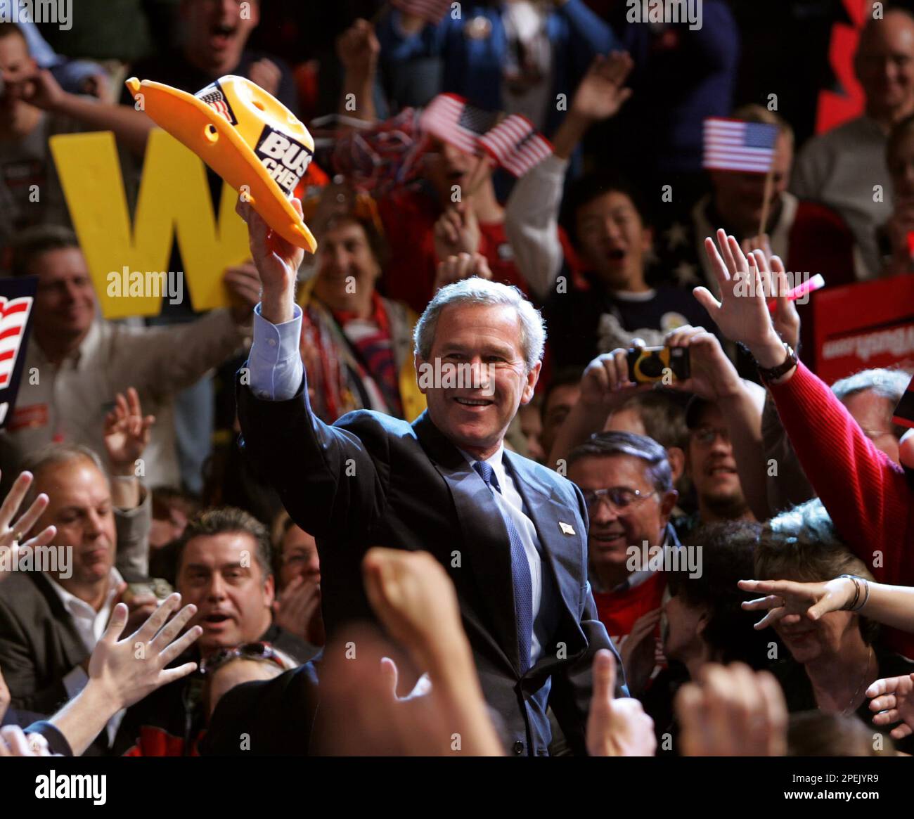 President Bush holds up a cowboy cheese hat as he is introduced at a ...