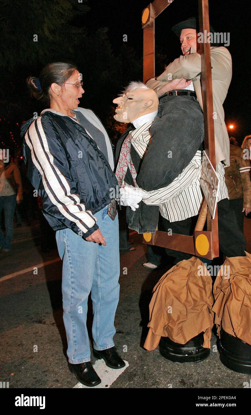 James Laubach, right, scares Michelle Seeber while dressed up like one ...