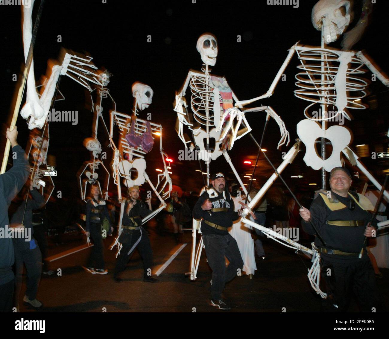 Puppeteers maneuver giant skeletons as they parade down Sixth Avenue in ...