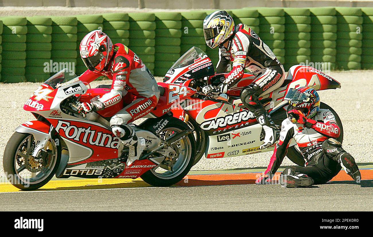 San Marino's 250cc rider Alex De Angelis, right, falls during the ...