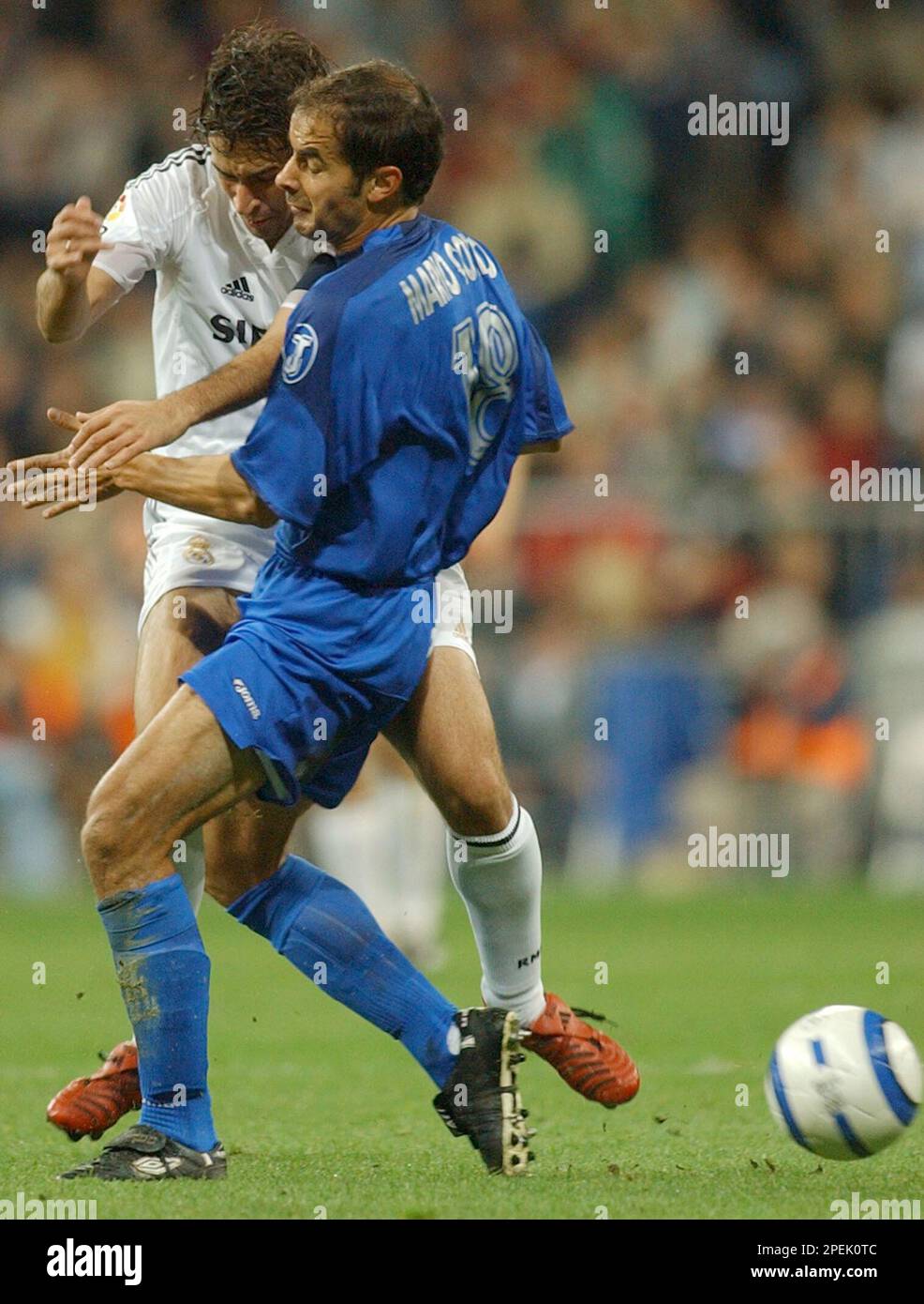 Real Madrid's striker Raul Gonzalez, left, is tackled by Getafe's Mario ...