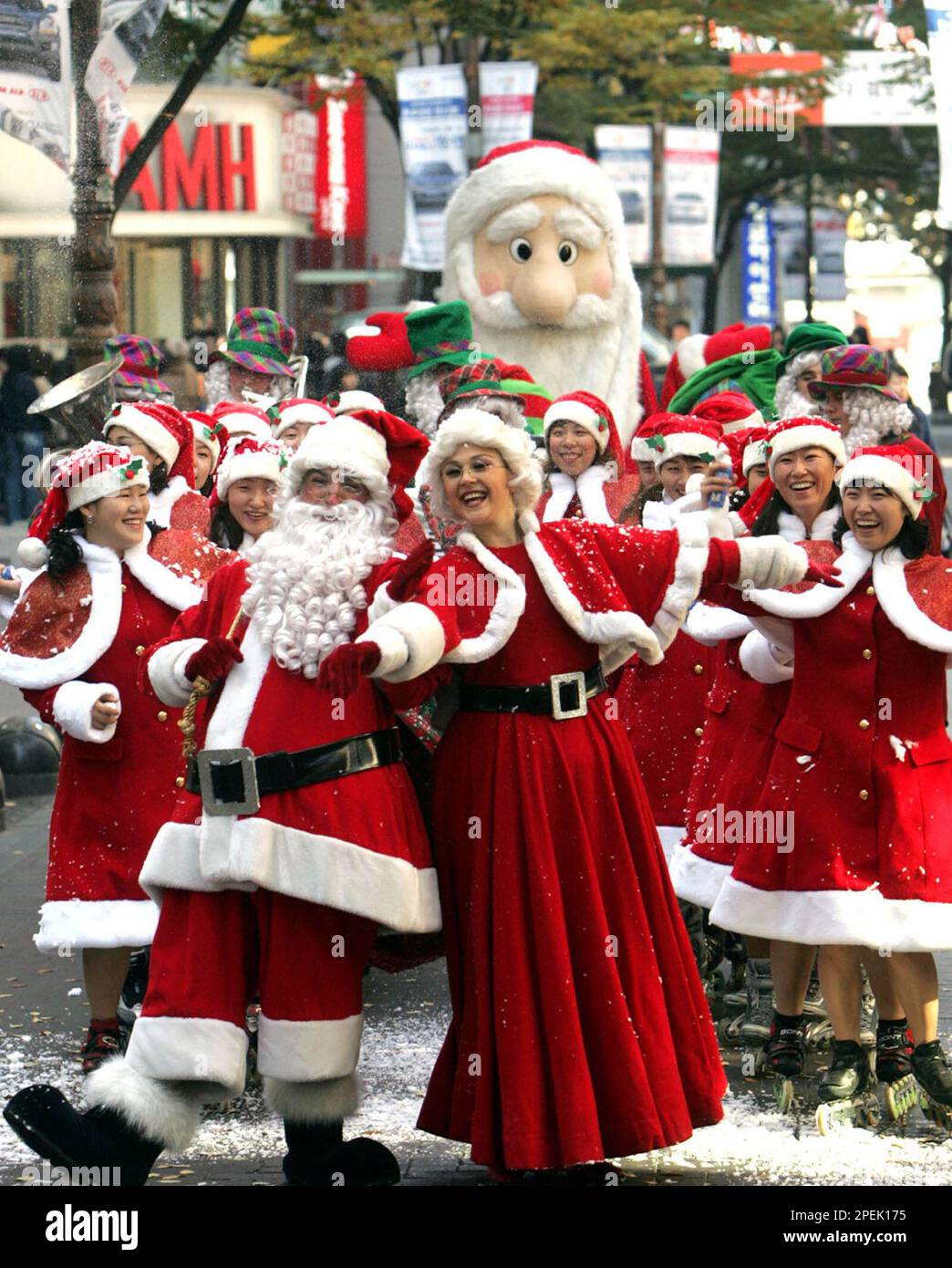 South Koreans in Santa Claus costume perform during a Christmas ...