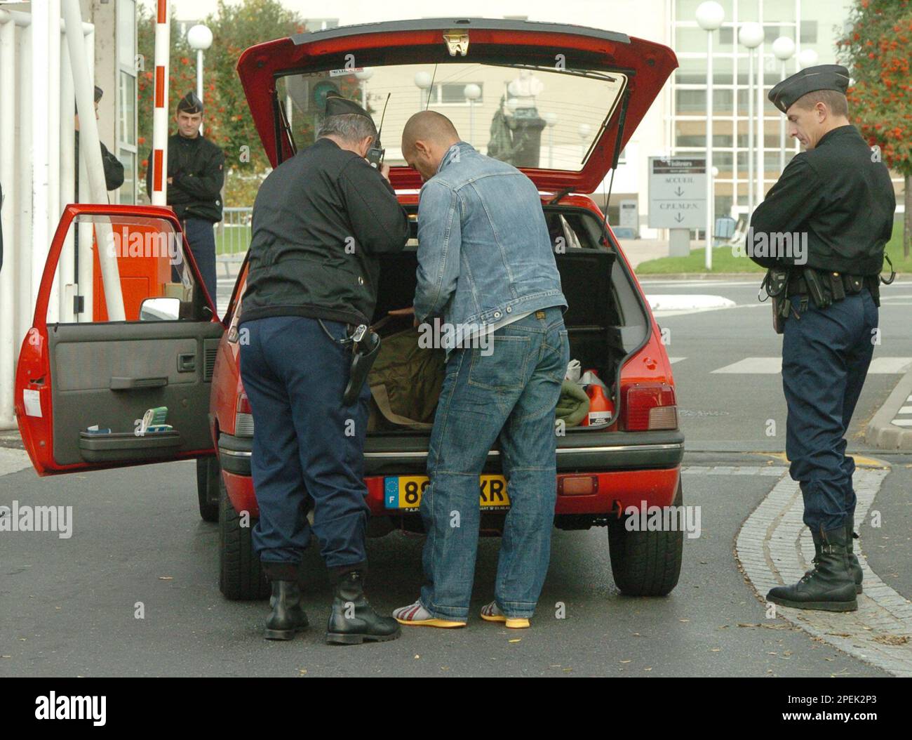 A vehicle is searched by French police officers as it arrives at the ...