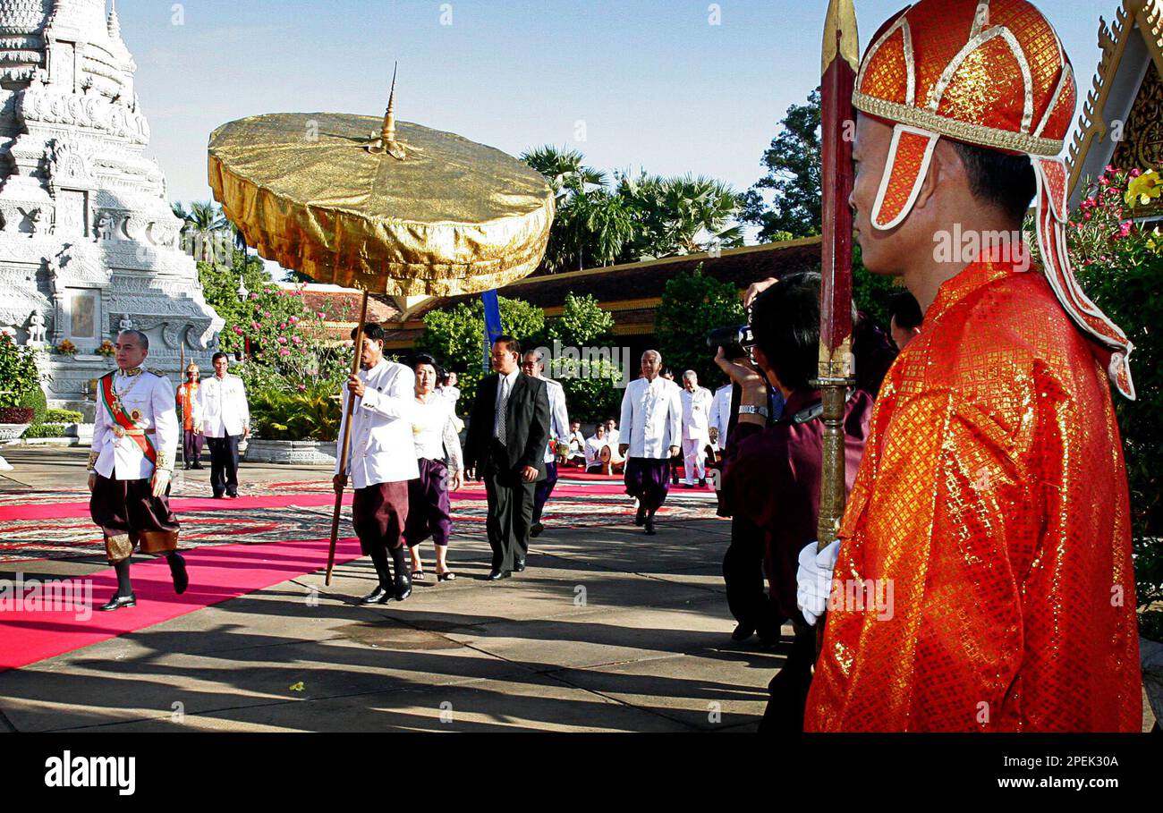 New Cambodian King Norodom Sihamoni, left, walks past ceremonial guards ...