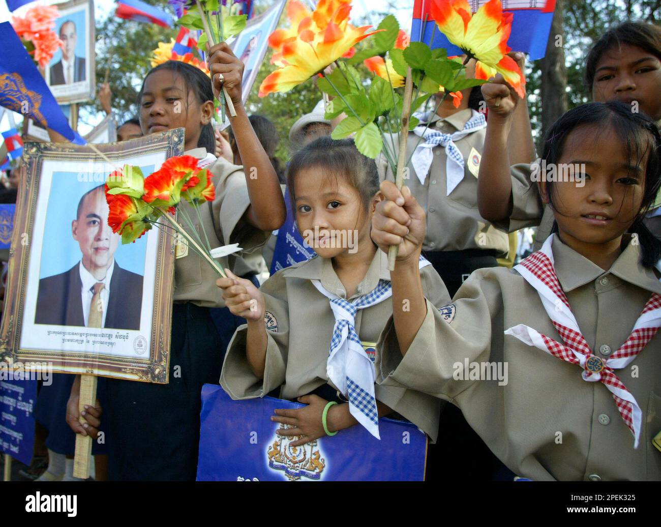 Cambodian girl guides cheer and wave flowers as King Norodom Sihamoni's ...
