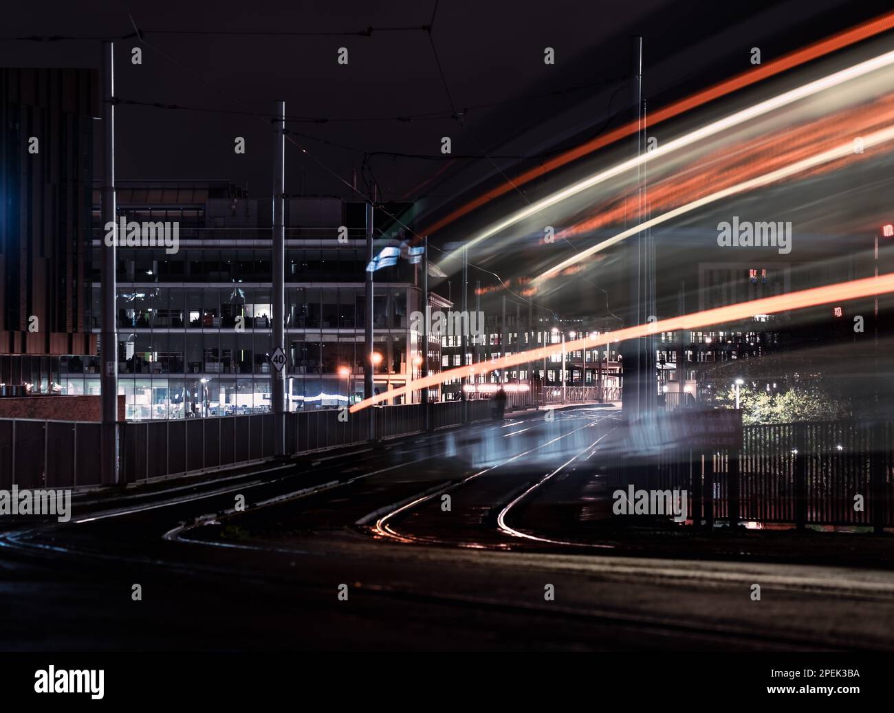 A long exposure shot of the light trails of the train over the railway ...