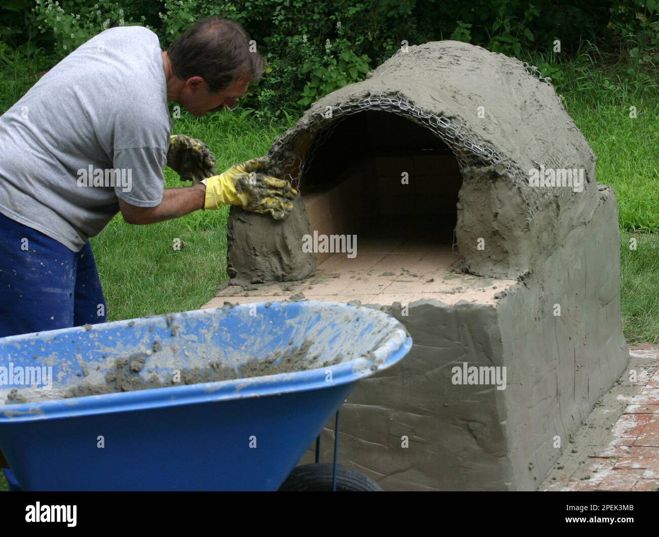 The wood fired pizza oven under construction. Ronald Hirsch applies the ...