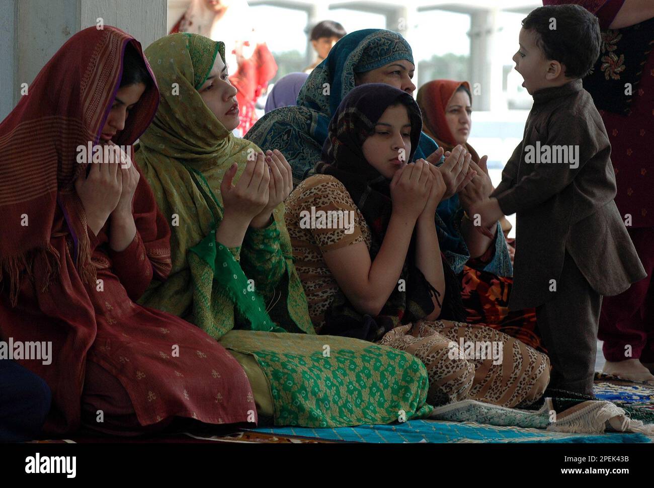 Muslim women offer prayers at the central mosque in Islamabad, Pakistan ...
